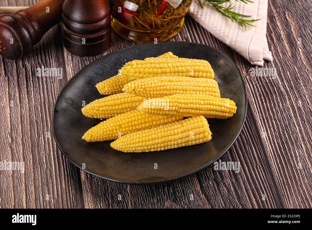 Canned baby mini corn cob in the plate Stock Photo - Alamy