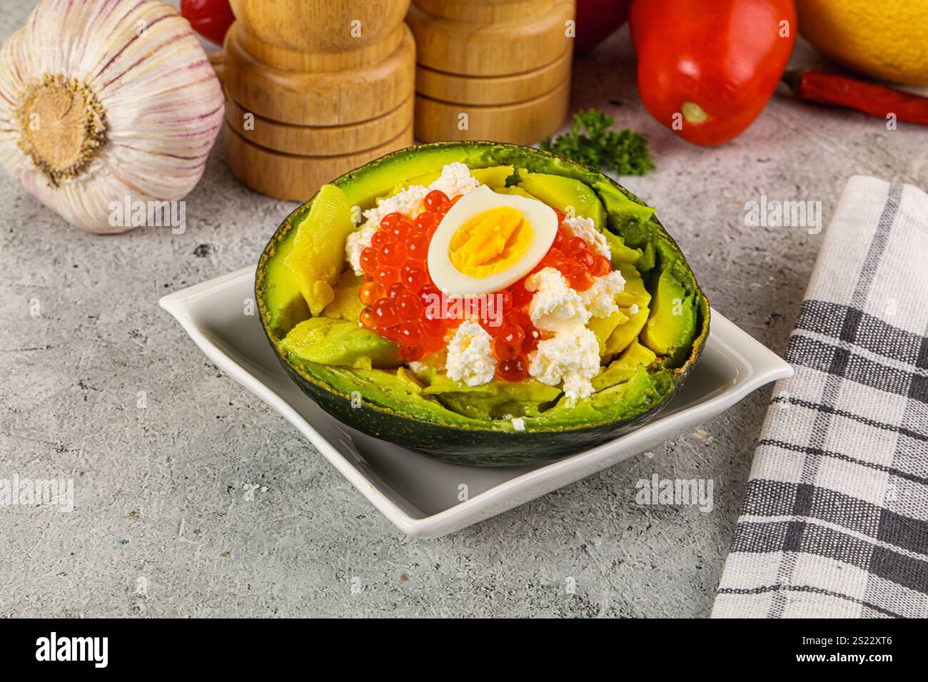 Avocado with red caviar and quil egg and soft cheese Stock Photo - Alamy