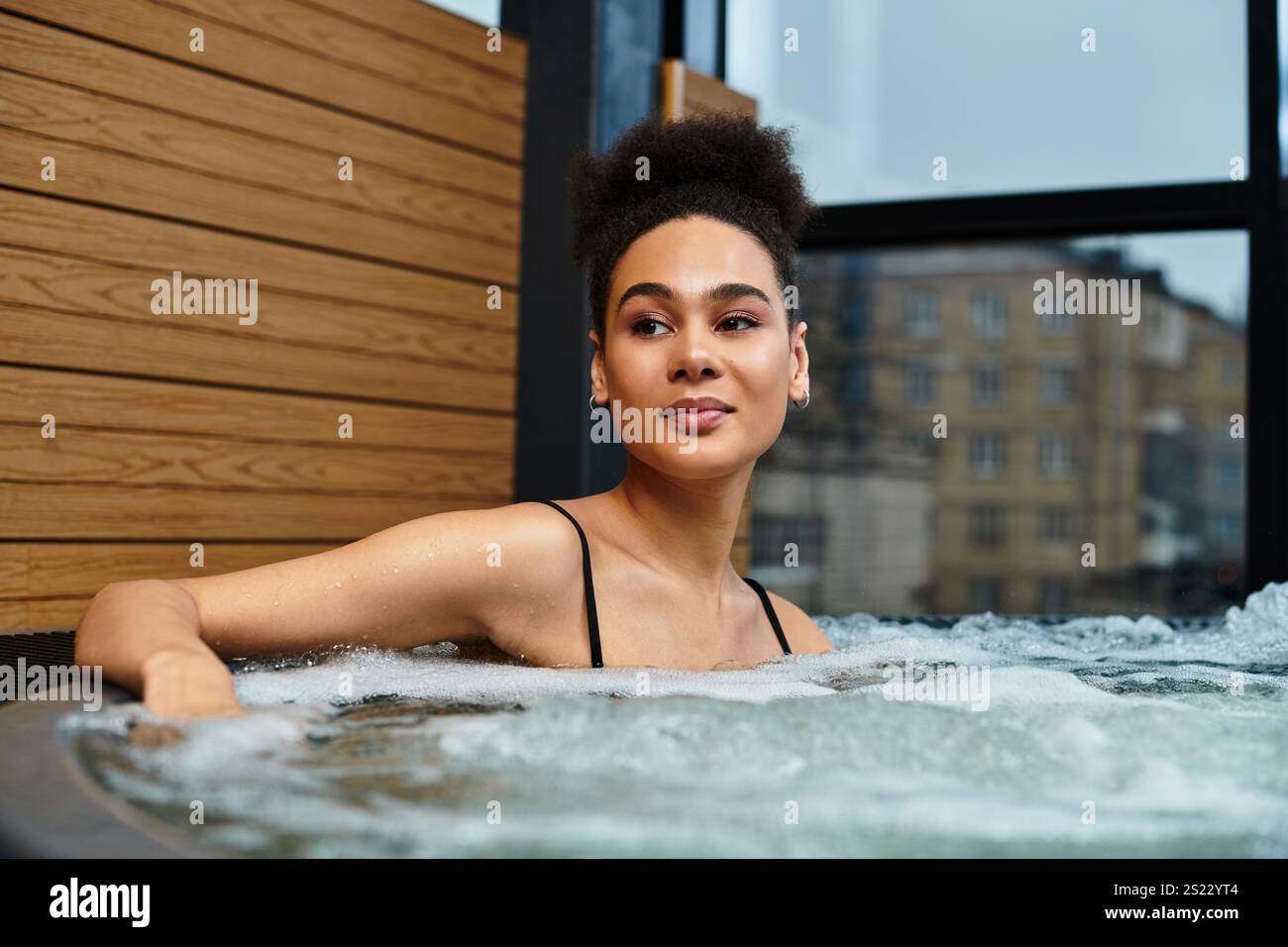 A beautiful young woman relaxes in a soothing spa, embracing ...