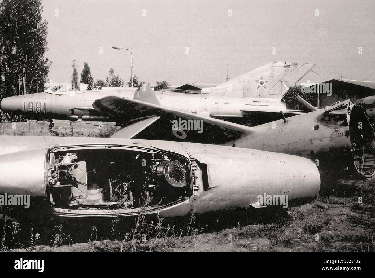 Two early MiG-21F-13 Fishbed Cs along with nearby MiG-15 rear fuselage ...