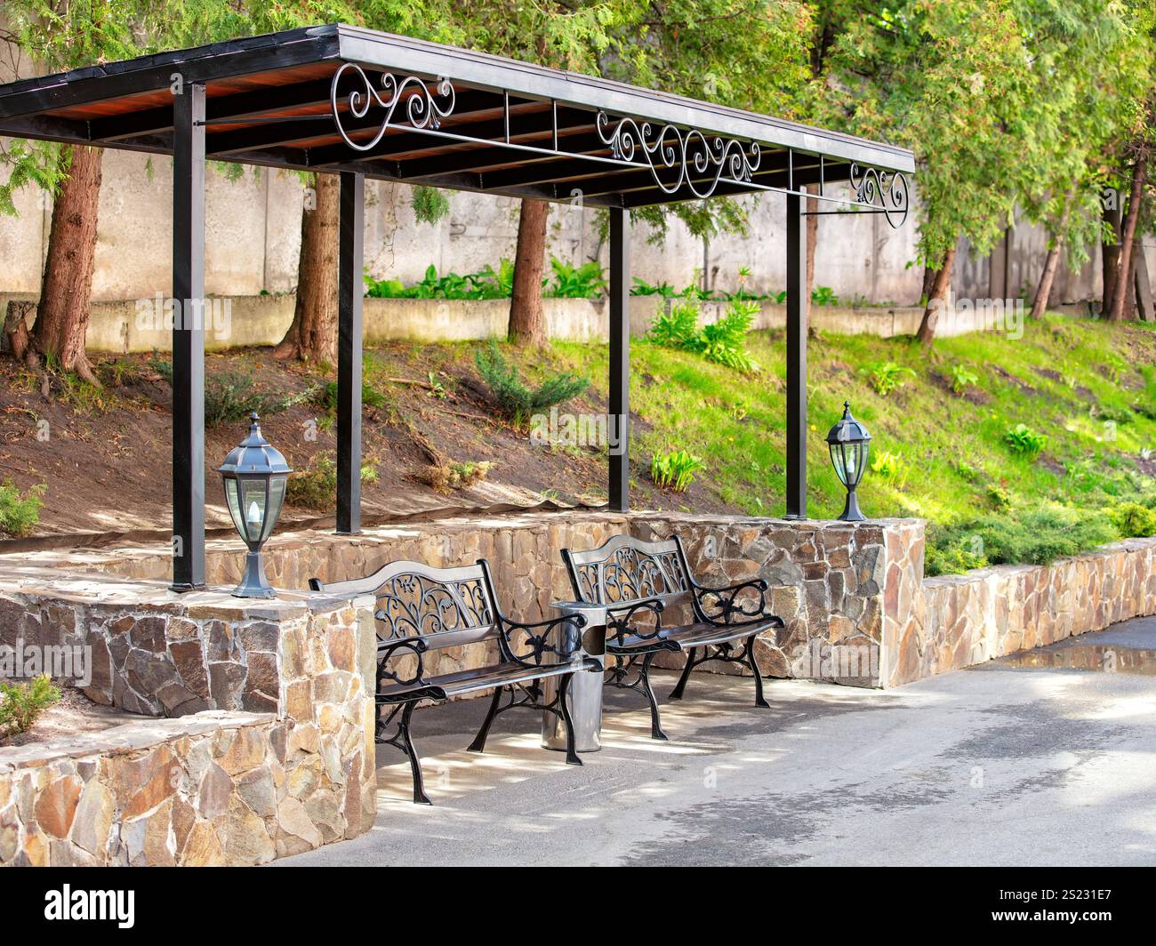 Elegant benches under a stylish canopy in a serene park setting during ...