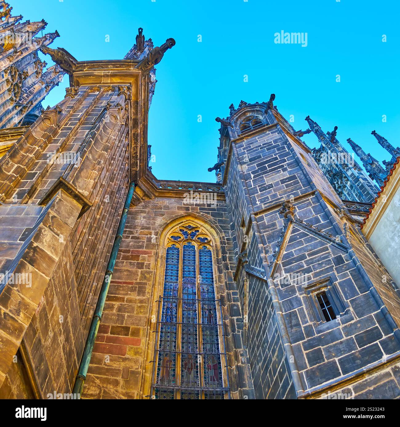 The ornate details of Gothic apse of St Vitus Cathedral, small carved ...