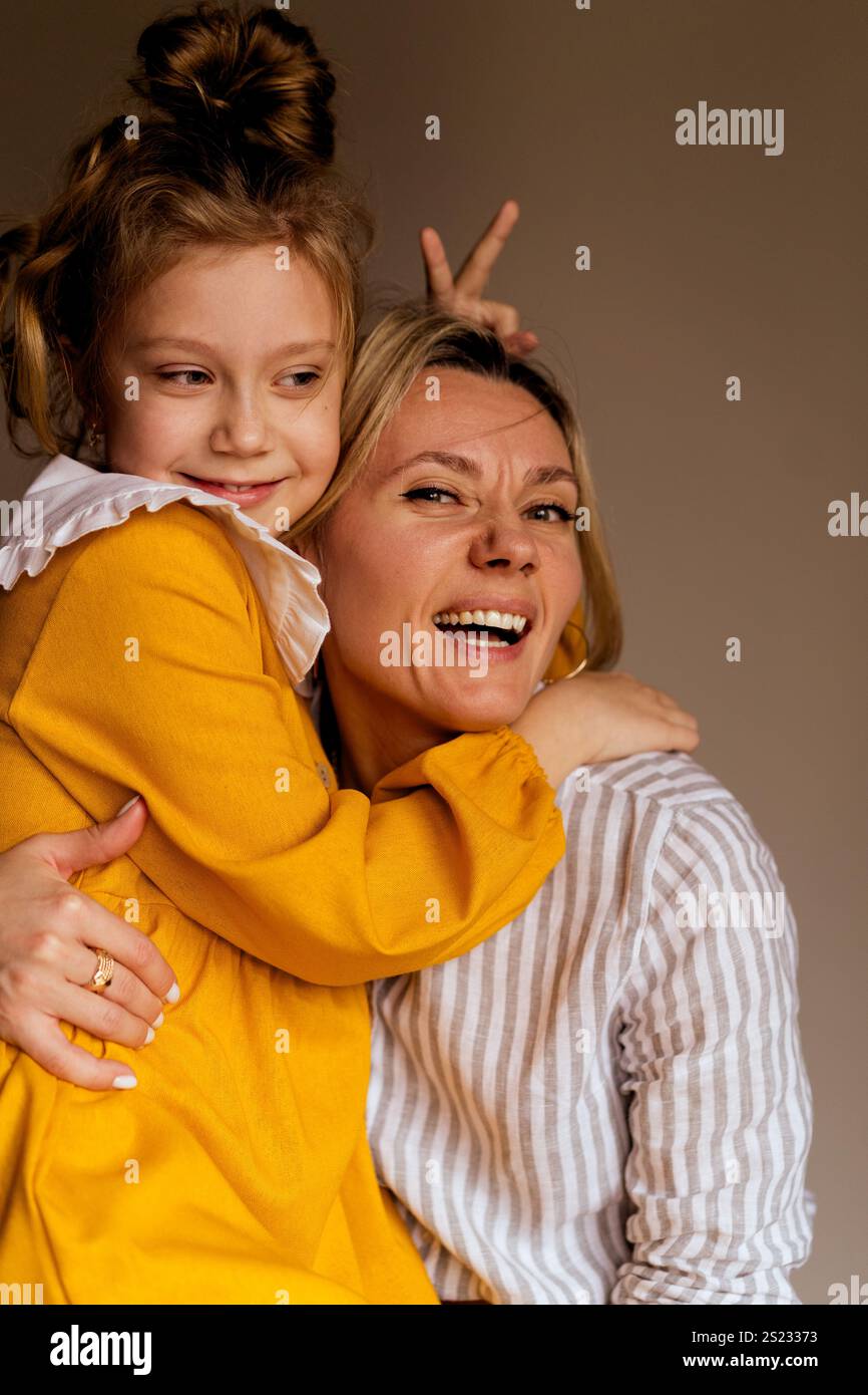 Mom and daughter hugging and laughing Stock Photo - Alamy
