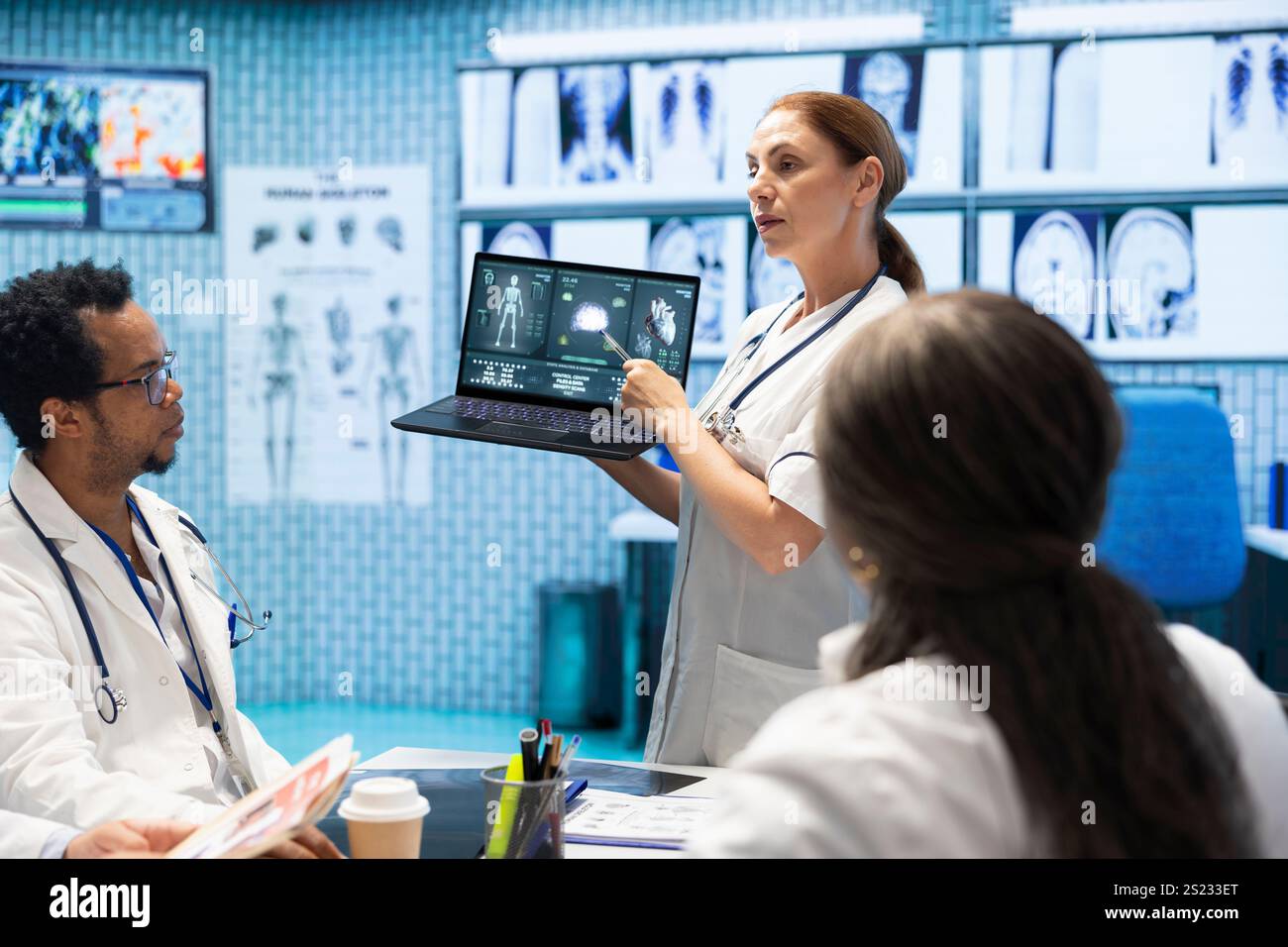 At a clinic, doctors and healthcare staff review test results and ct ...