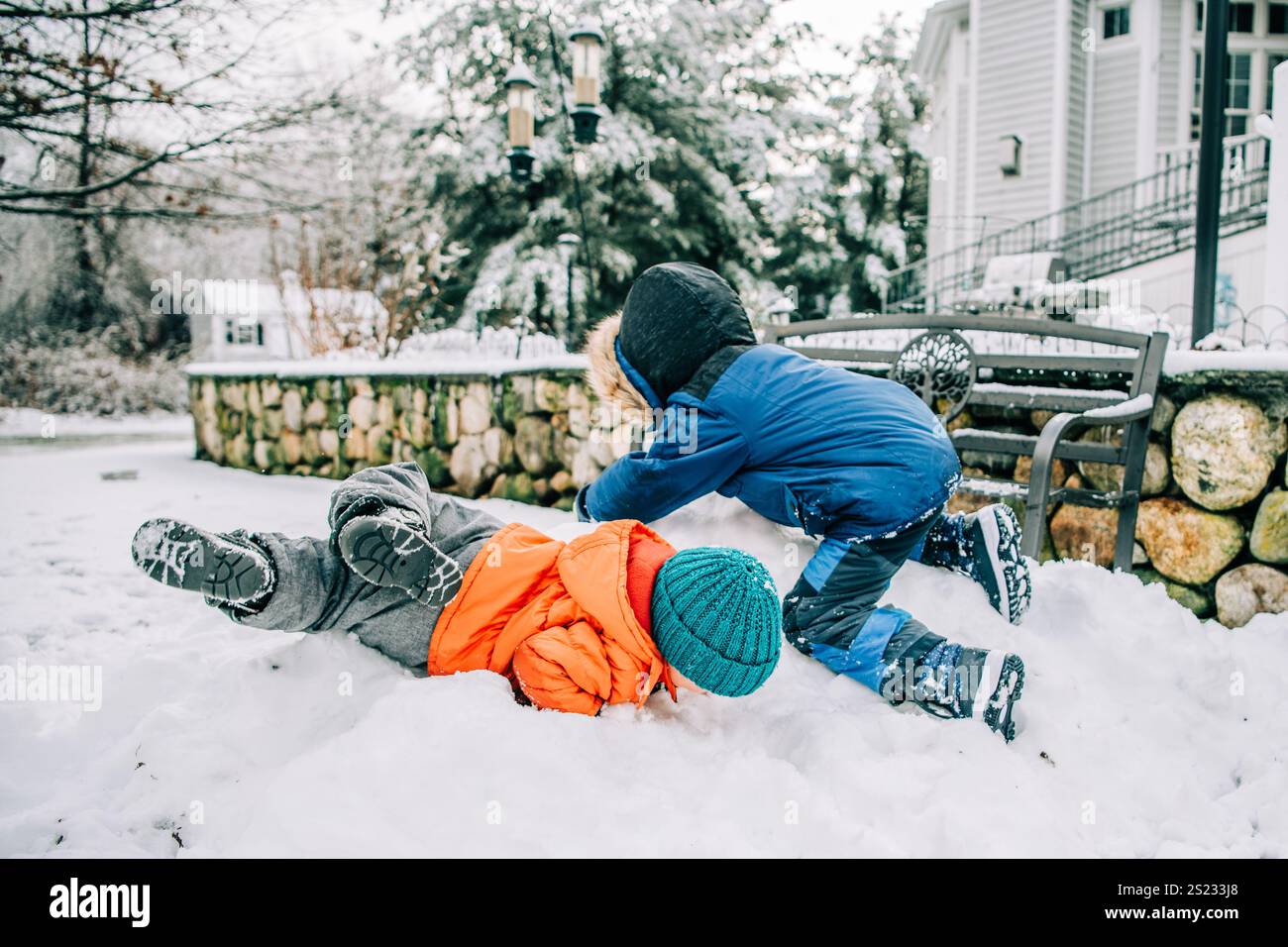 Cheerful children playing in snow hi-res stock photography and images ...