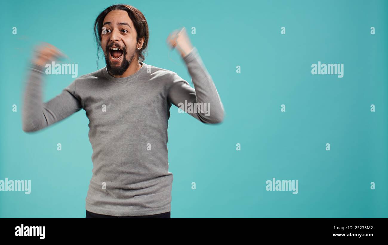 Man jumping from joy in excitement while cheering for favorite sports ...