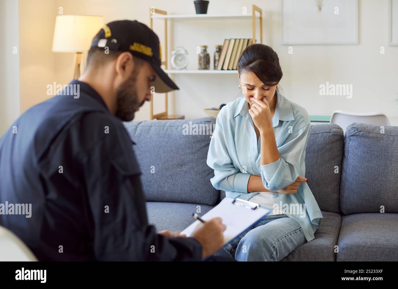 Police officer talking to robbery victim after burglary at home ...