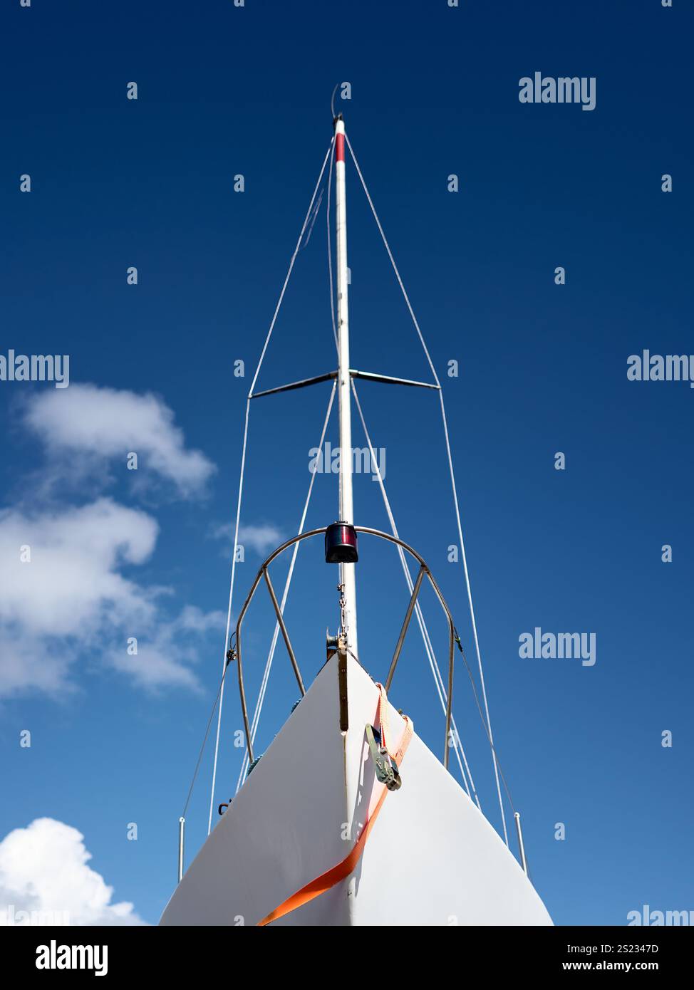 From below modern sailboat and mast connected with cables while front ...