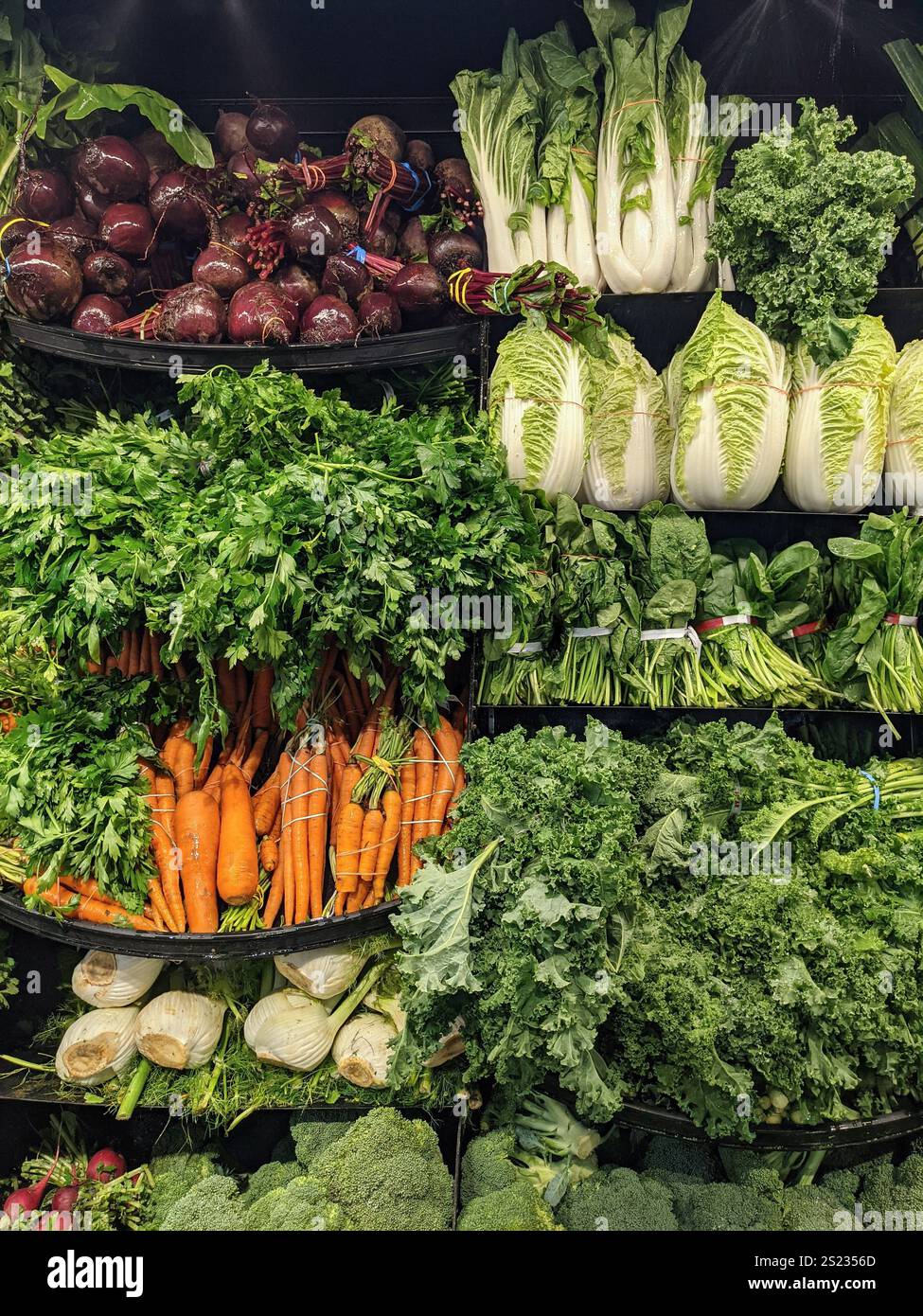 Fresh produce display of carrots, kale, beets, and leafy greens Stock ...