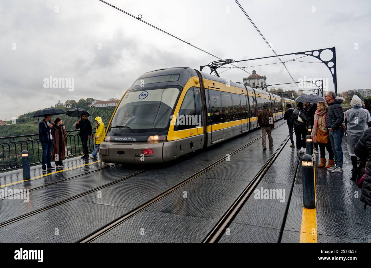 Tram passing over the crowded Don Luis Bridge in Porto, Portugal ...