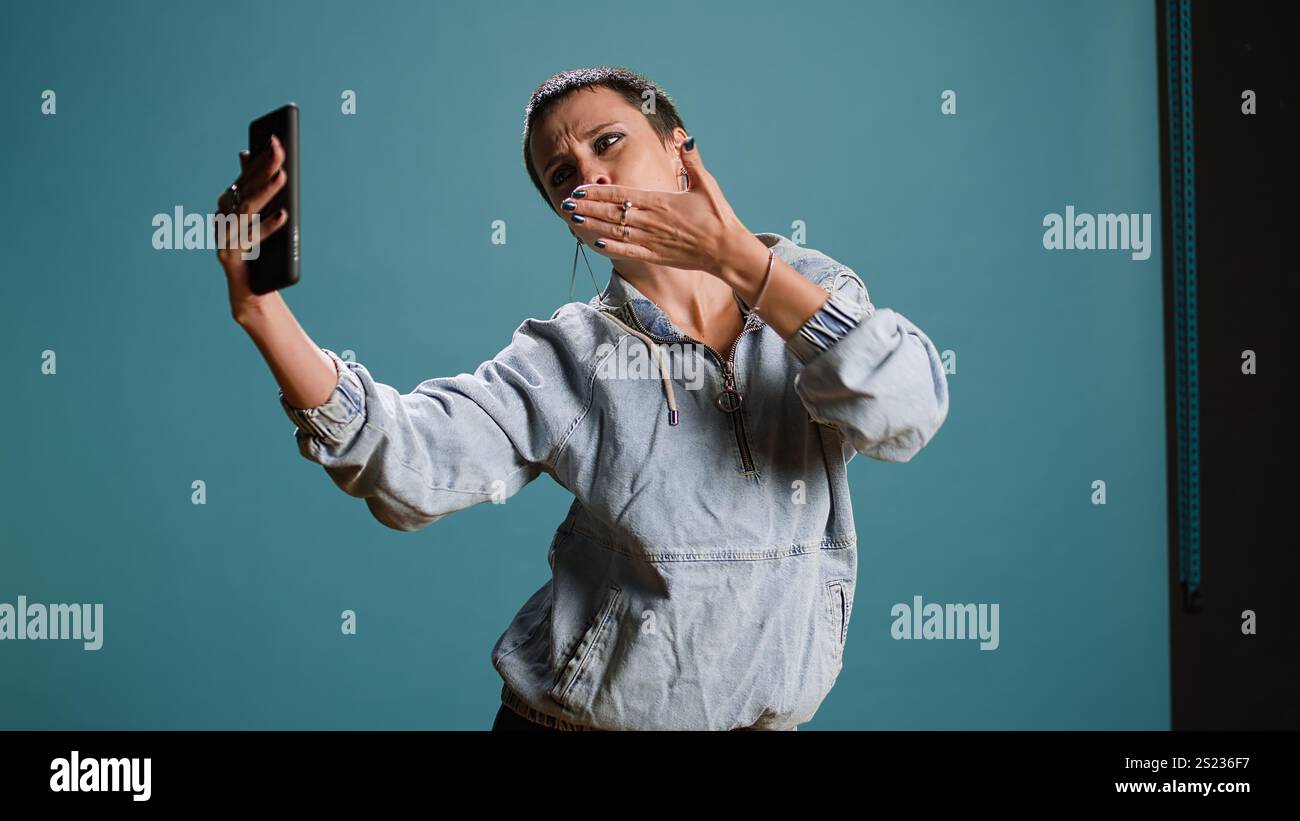 Silly confident woman recording a video while she shows groovy dance ...