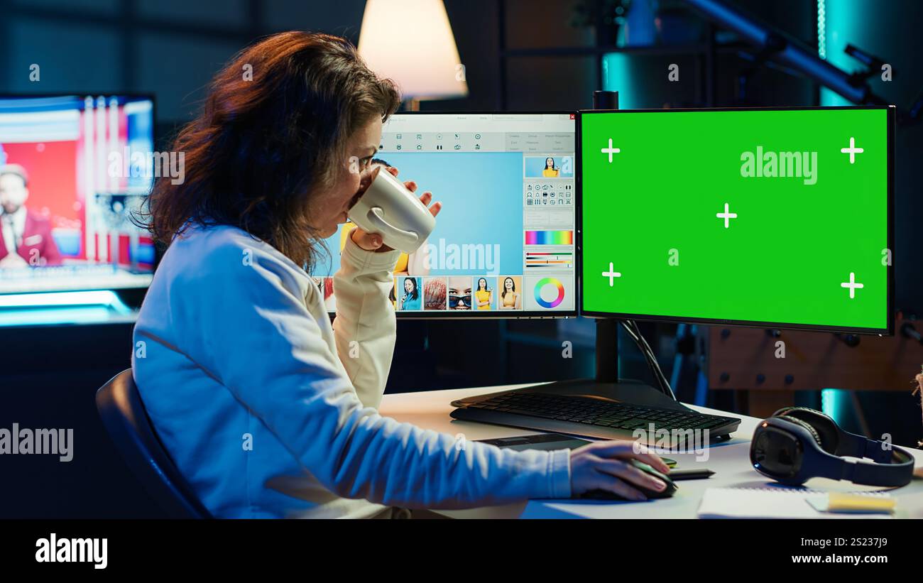 Content specialist uses graphic design skills to make social media post on green screen computer ...