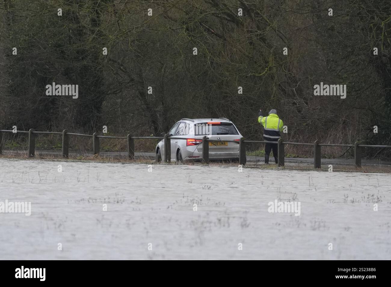 A vehicle is driven through floodwater in Yalding, Kent. Weather ...
