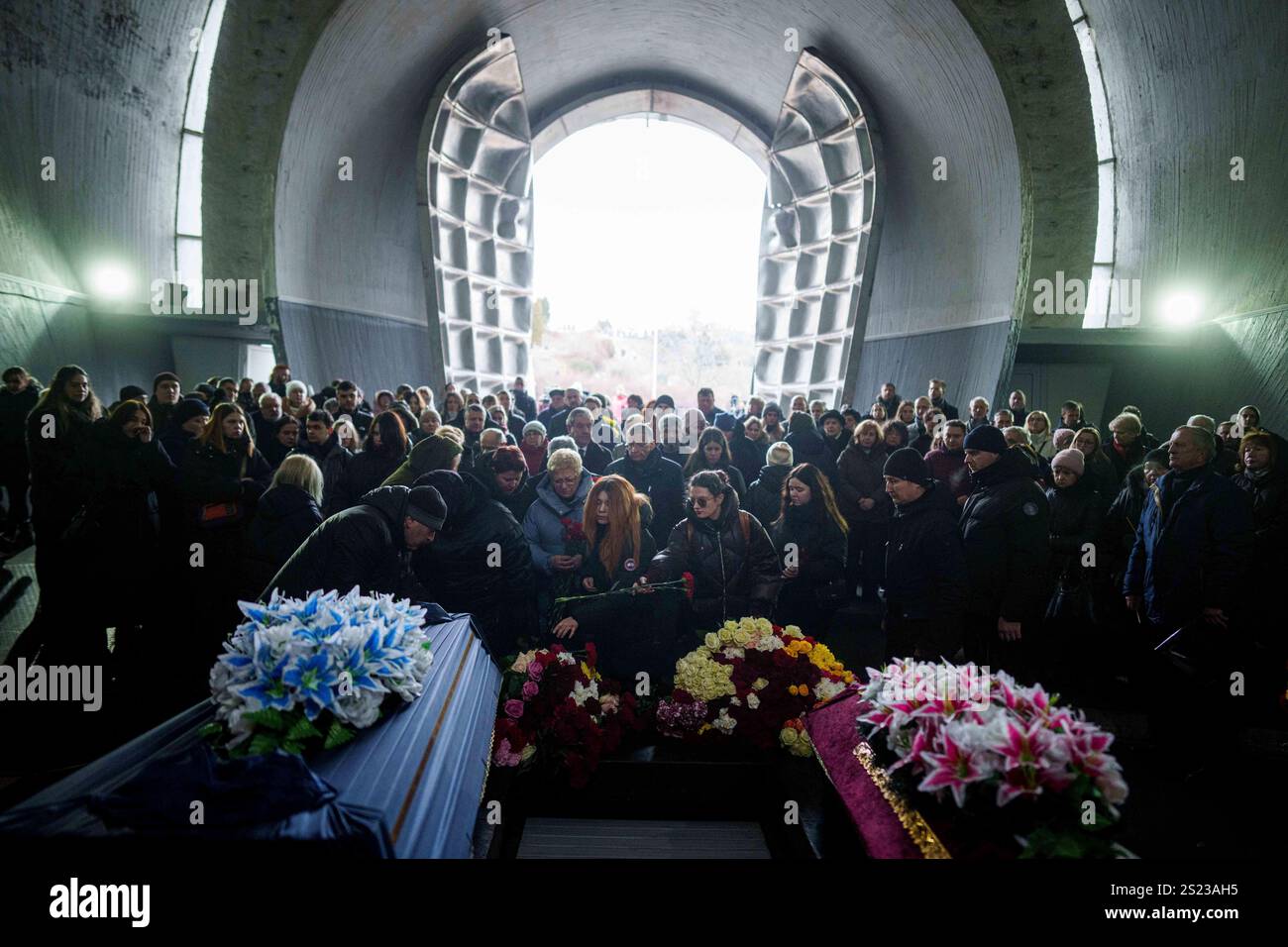 People attend the funeral ceremony of neurobiologist Ihor Zyma and his ...