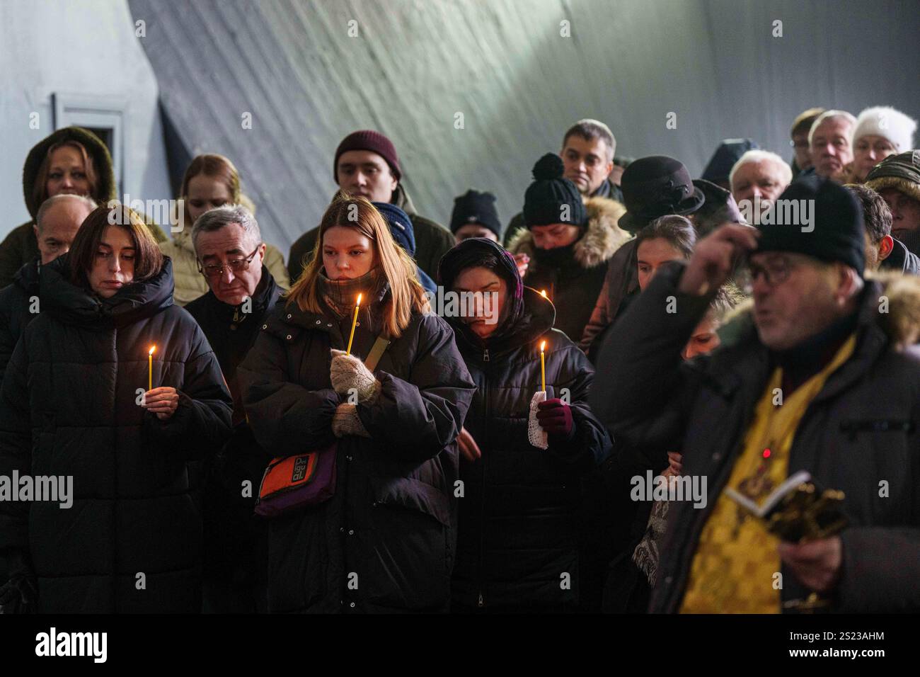 Relatives and friends hold candles during the funeral ceremony of ...