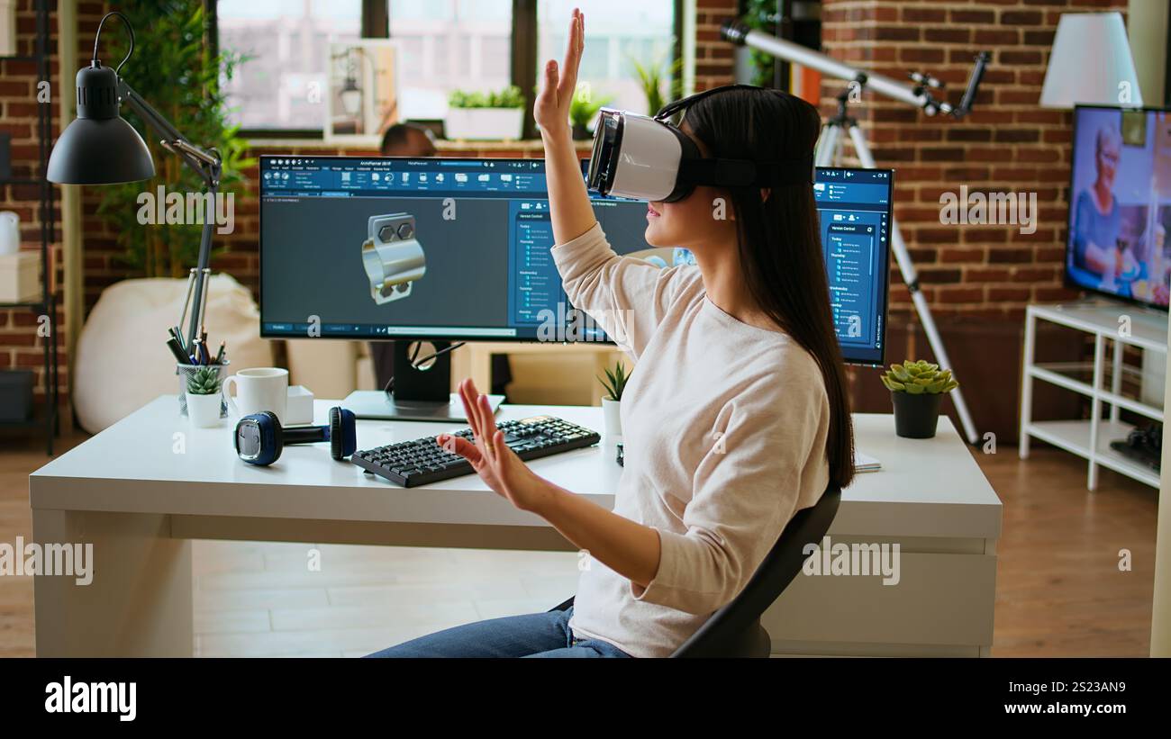Asian woman engineer creating prototypes with vr glasses and 3D modeling software, working from ...
