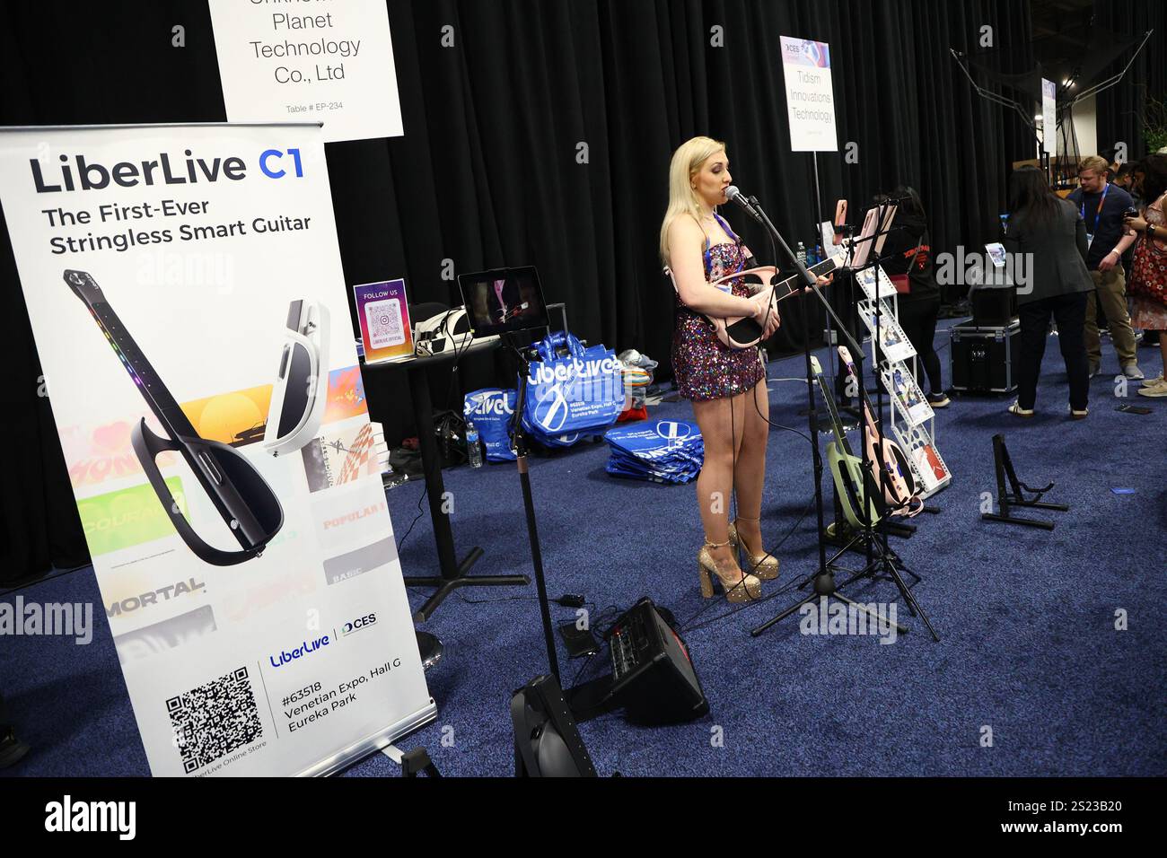 A musician demonstrates the LiberLive C1 Stringless Smart Guitar during ...