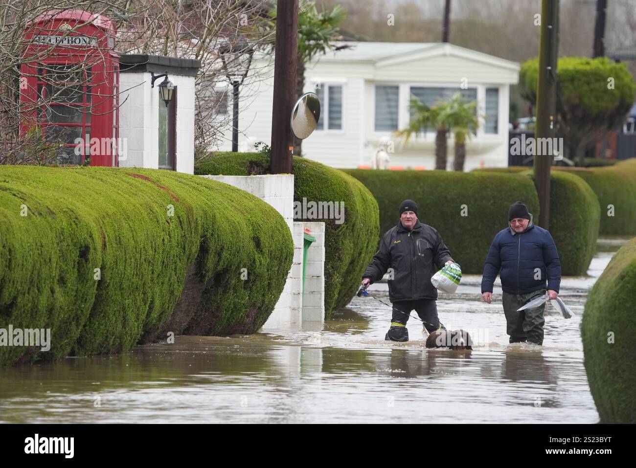 People walk through flood water at the Little Venice caravan park in ...
