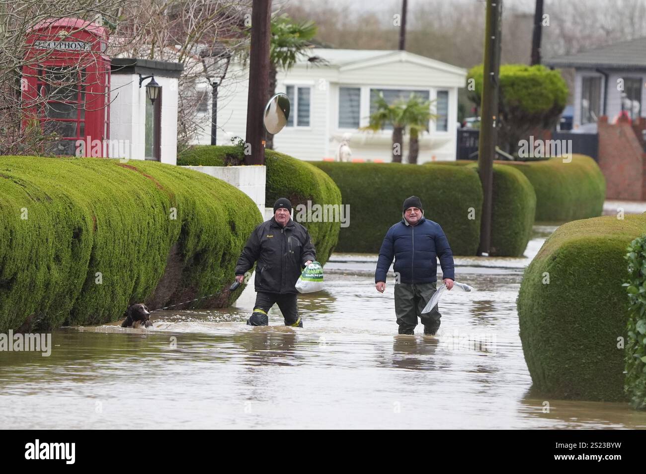 People walk through flood water at the Little Venice caravan park in ...