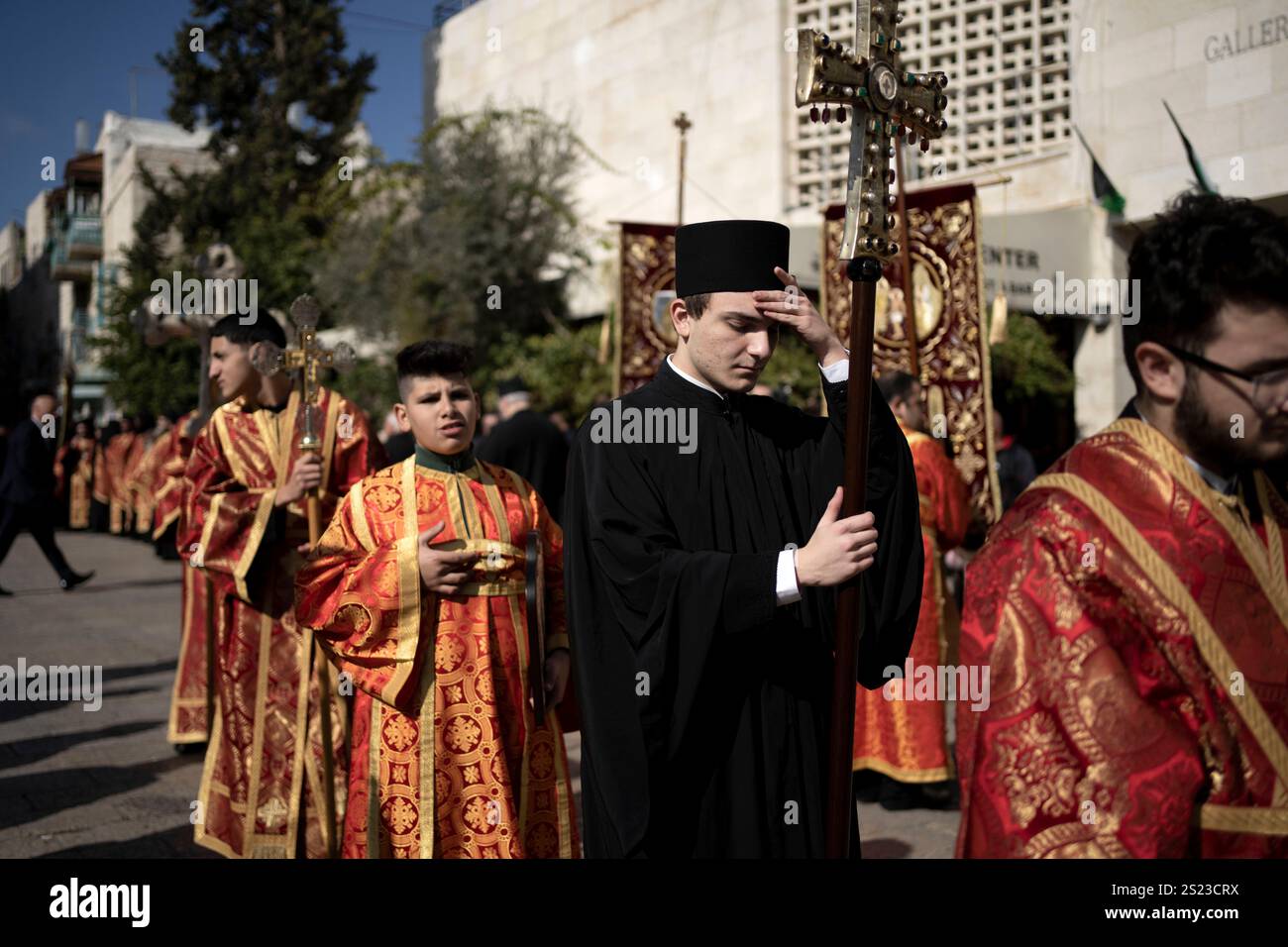 A Greek Orthodox altar boy pauses in Manger Square near the Church of ...