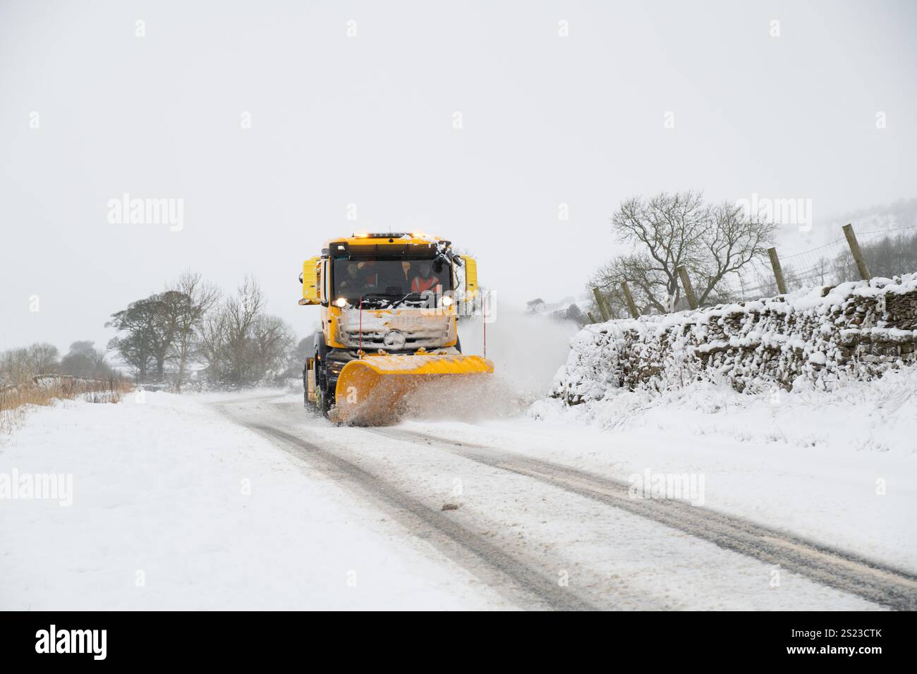 Spreading and snow ploughing the road Stock Photo - Alamy