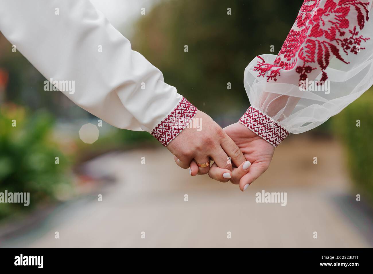 Romantic Intertwined Hands in Traditional Embroidered Attire Stock ...