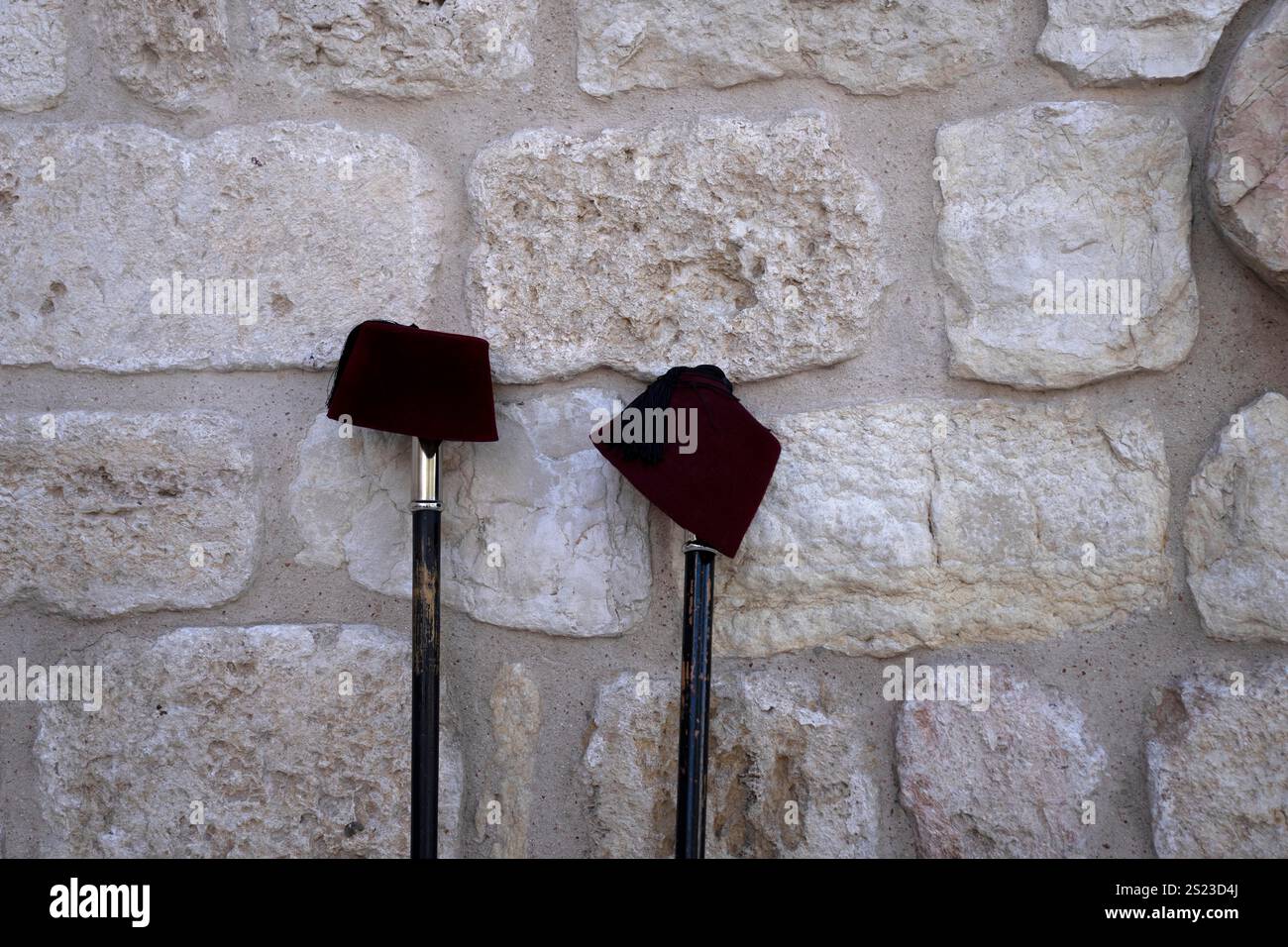 Hats and walking staffs belonging to ceremonial guards lean on the ...