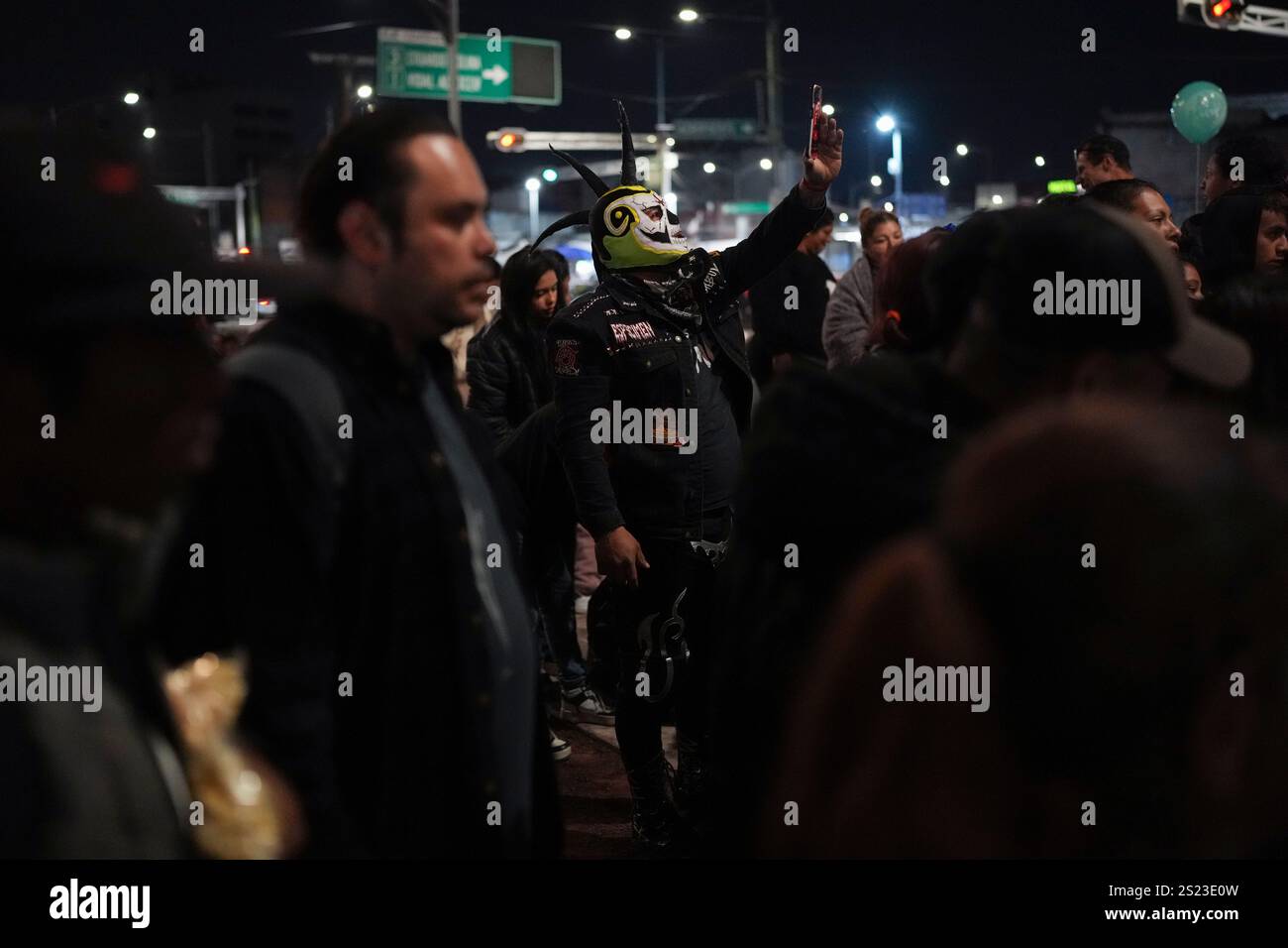 A volunteer of the group known as the Punk Kings takes photos during ...