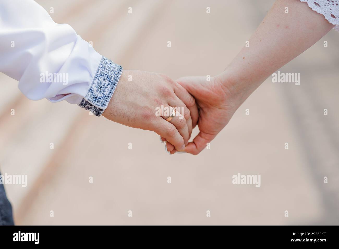 Romantic Moment: A Close-Up of Intertwined Hands with Wedding Ring ...