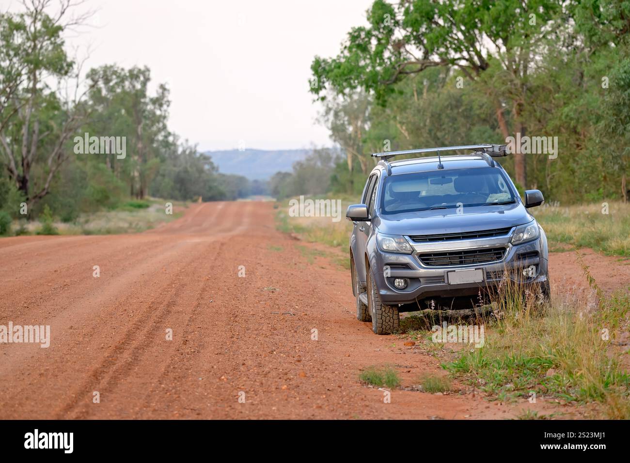 4WD car vehicle beside outback red dirt track road, Australian bush ...