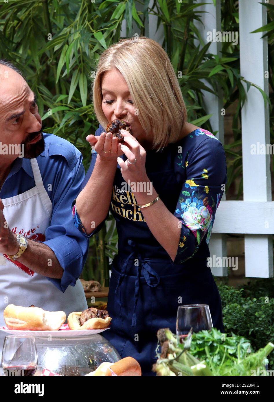 Kelly Ripa takes part in an outdoor cooking segment on the sidewalk ...