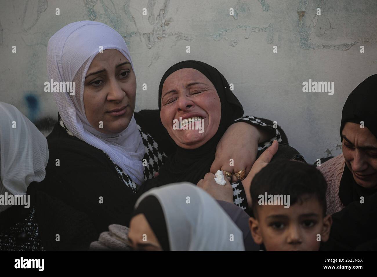 Palestinians carry the body of Moataz al-Madani, 16, who was killed during clashes with Israeli ...