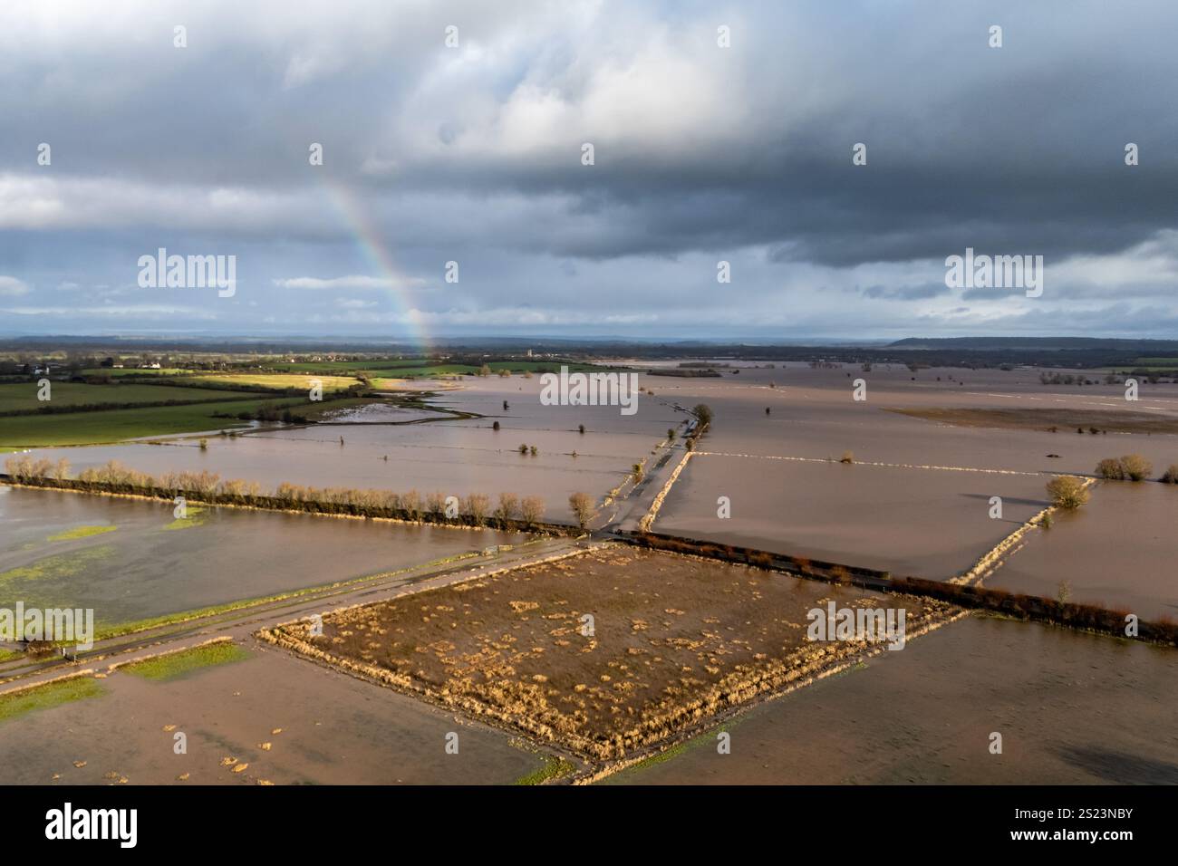 A rainbow is seen over flooded fields near the River Tone in Somerset ...
