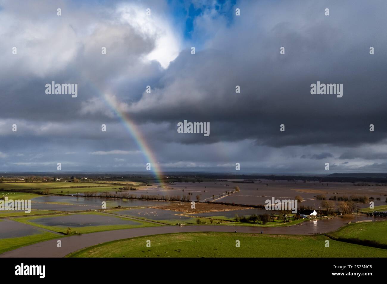 A rainbow is seen over flooded fields near the River Tone in Somerset ...