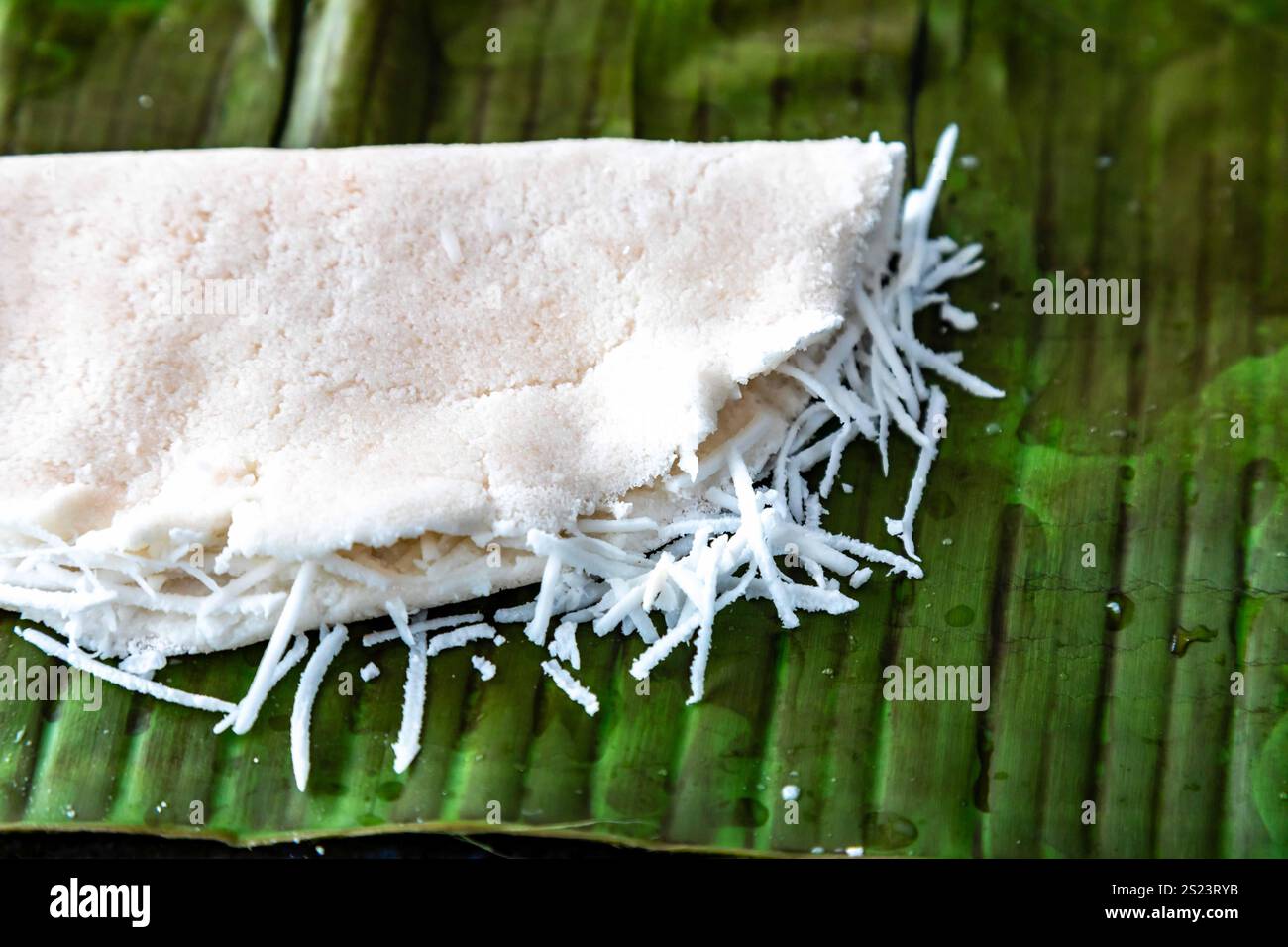 Traditional Brazilian tapioca with coconut served on a banana leaf ...