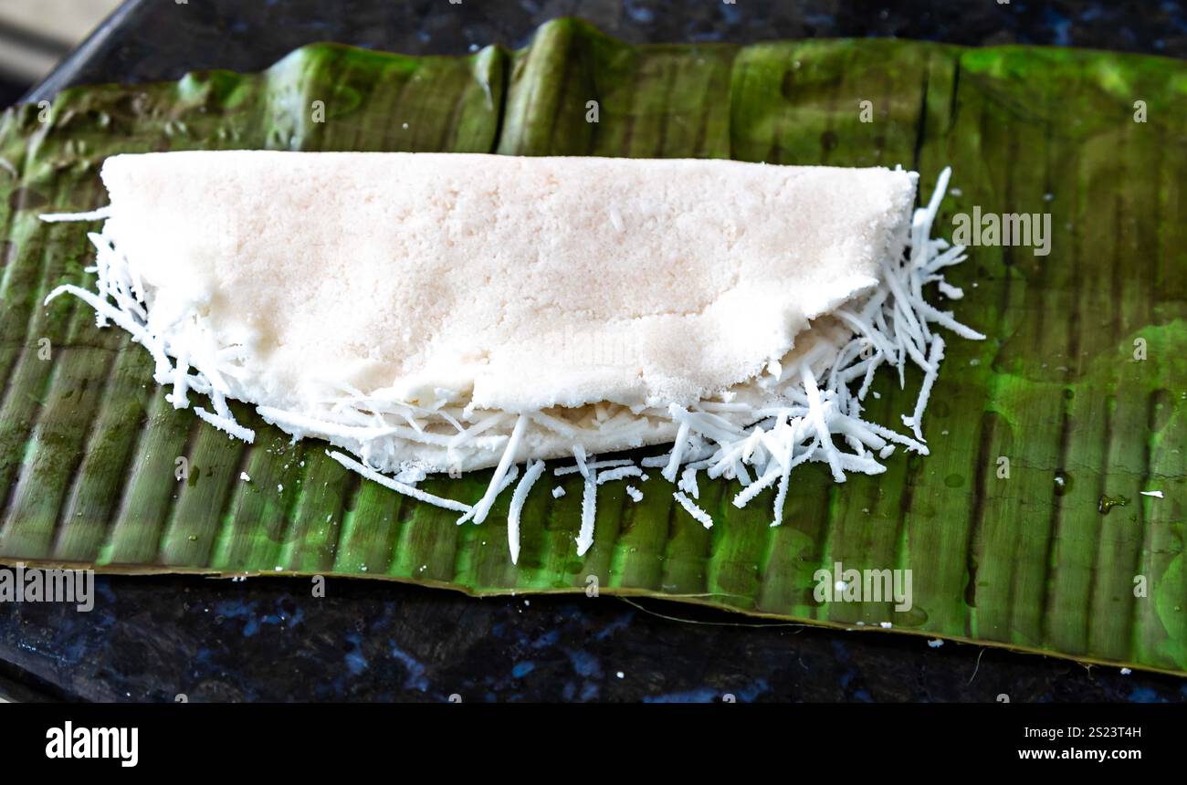 Traditional Brazilian tapioca with coconut served on a banana leaf ...