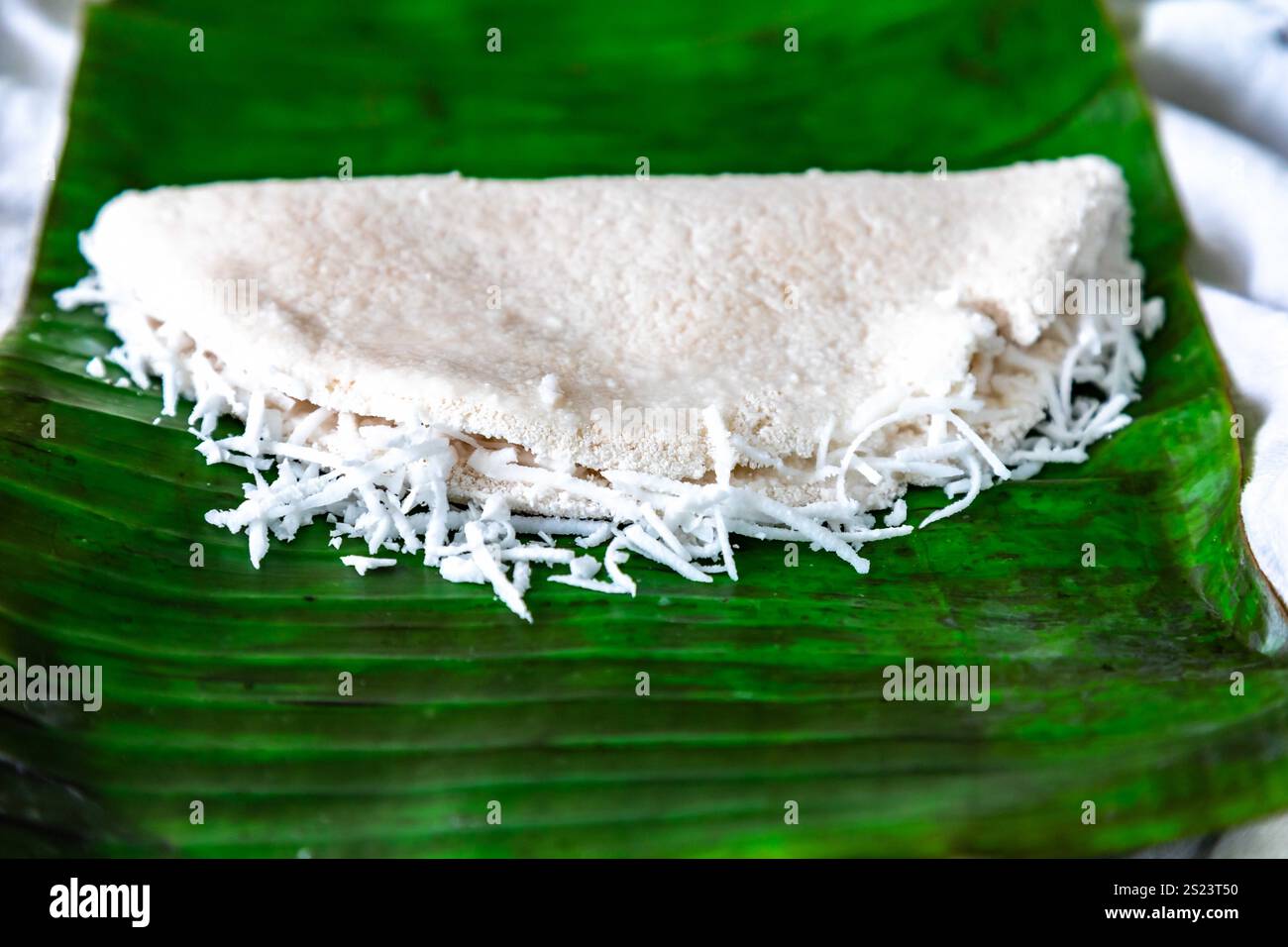 Traditional Brazilian tapioca with coconut served on a banana leaf ...