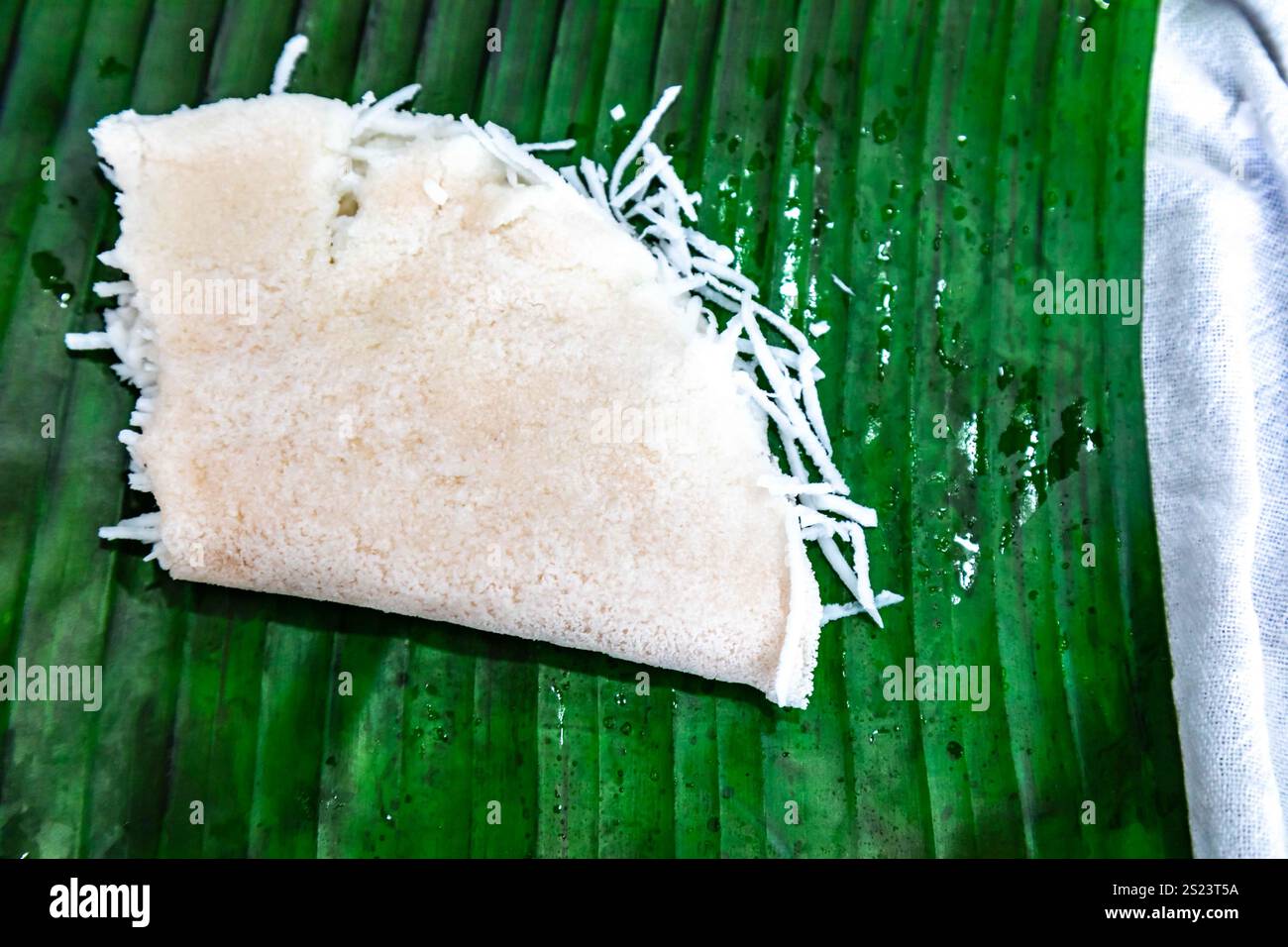Traditional Brazilian tapioca with coconut served on a banana leaf ...