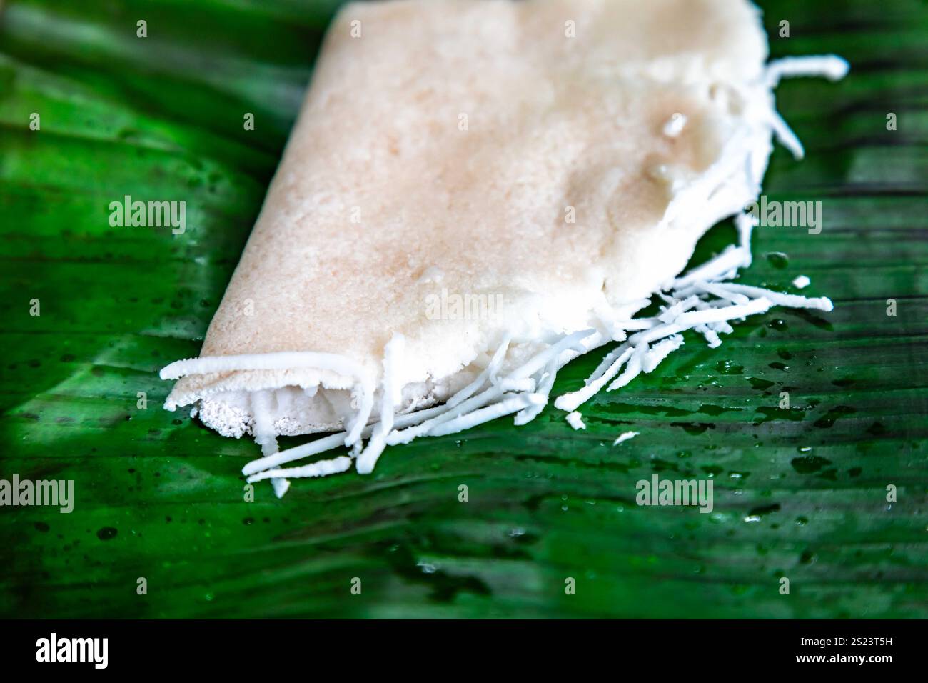 Traditional Brazilian tapioca with coconut served on a banana leaf ...