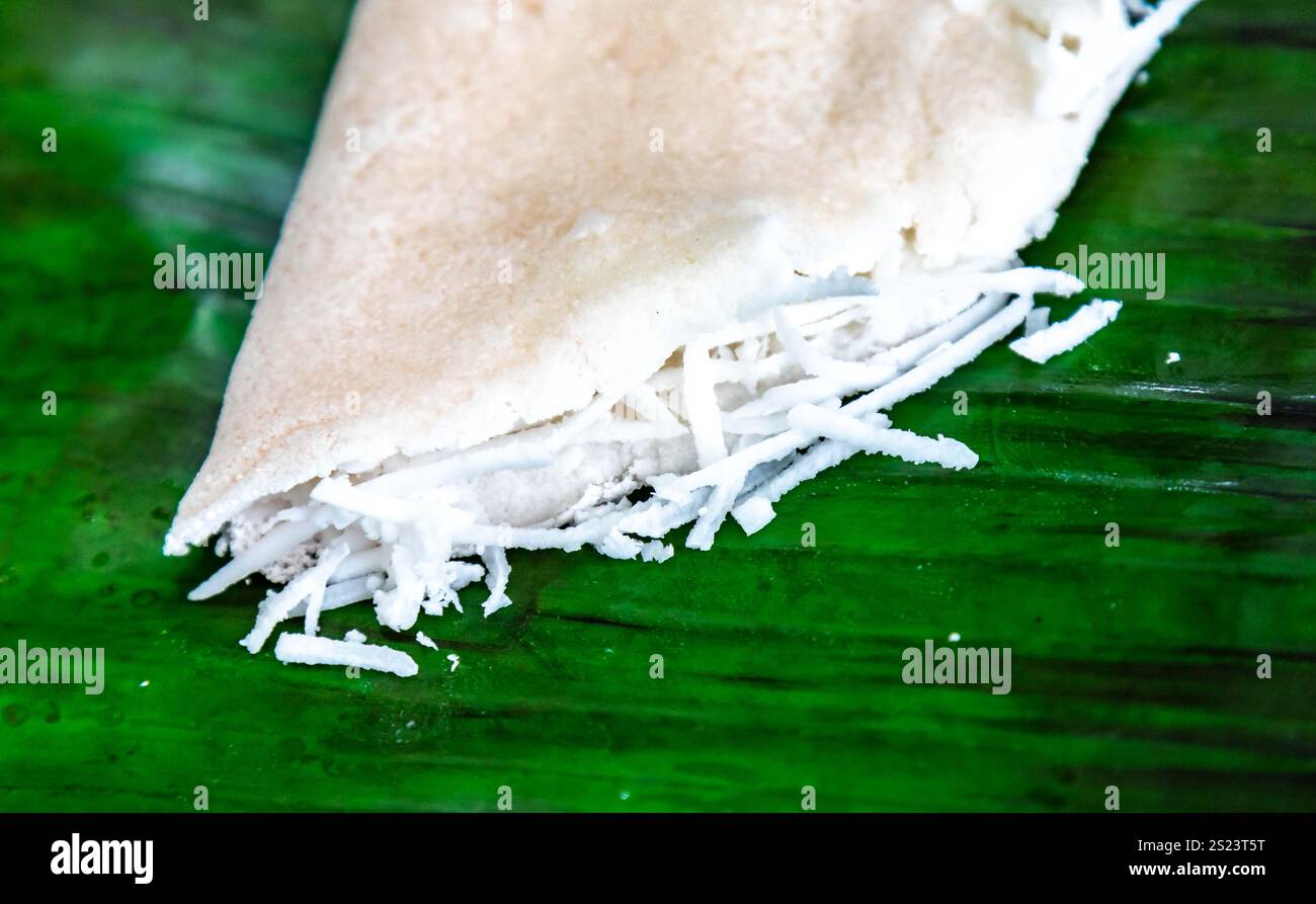 Traditional Brazilian tapioca with coconut served on a banana leaf ...
