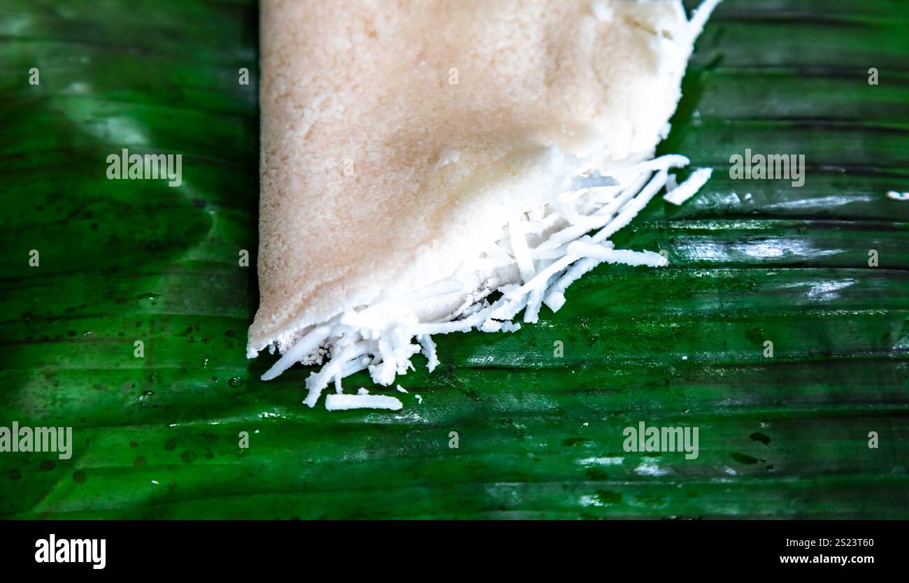 Traditional Brazilian tapioca with coconut served on a banana leaf ...