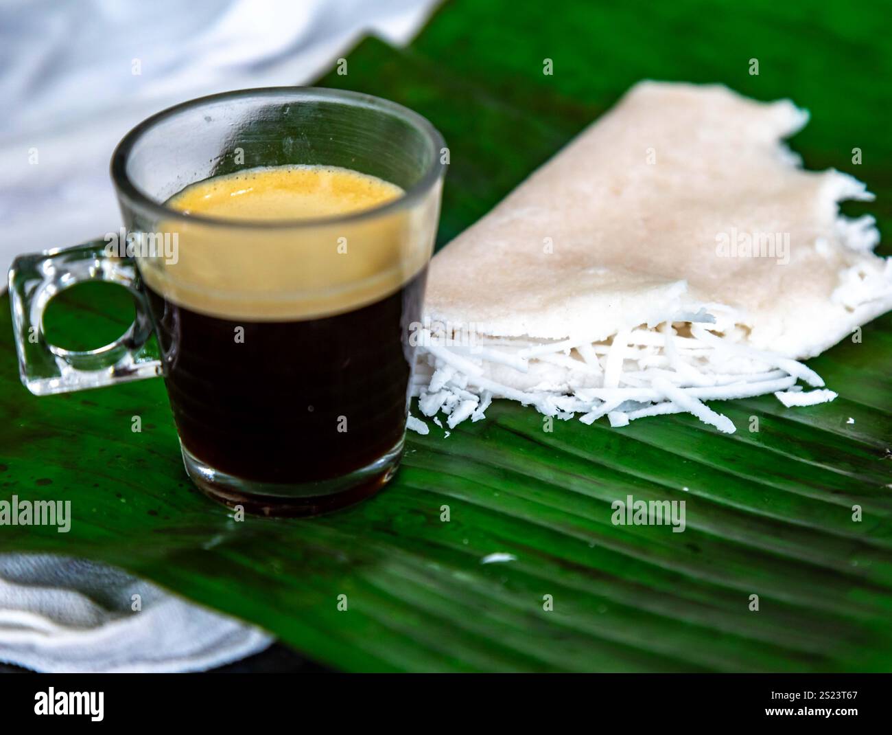 Traditional Brazilian tapioca with coconut served on a banana leaf ...
