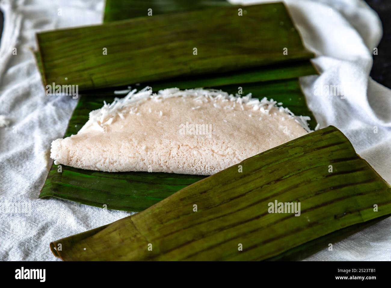 Traditional Brazilian tapioca with coconut served on a banana leaf ...