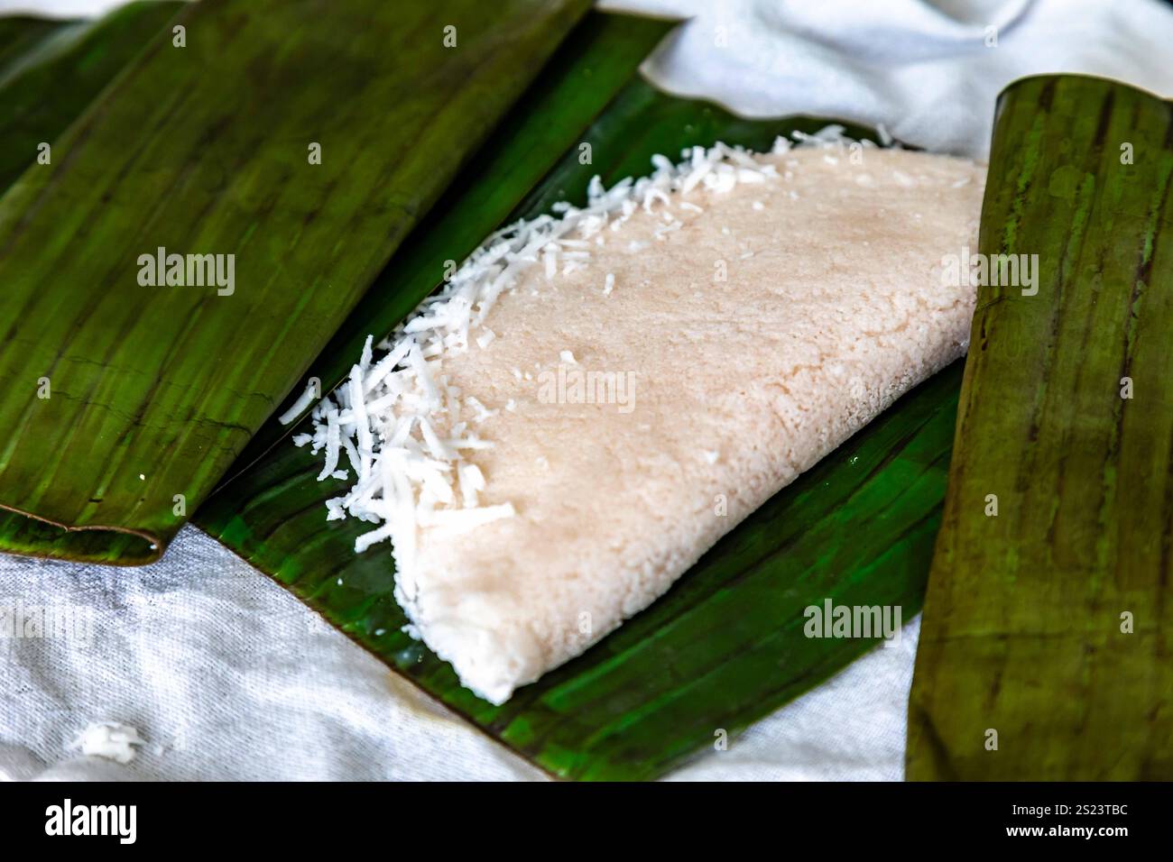 Traditional Brazilian tapioca with coconut served on a banana leaf ...