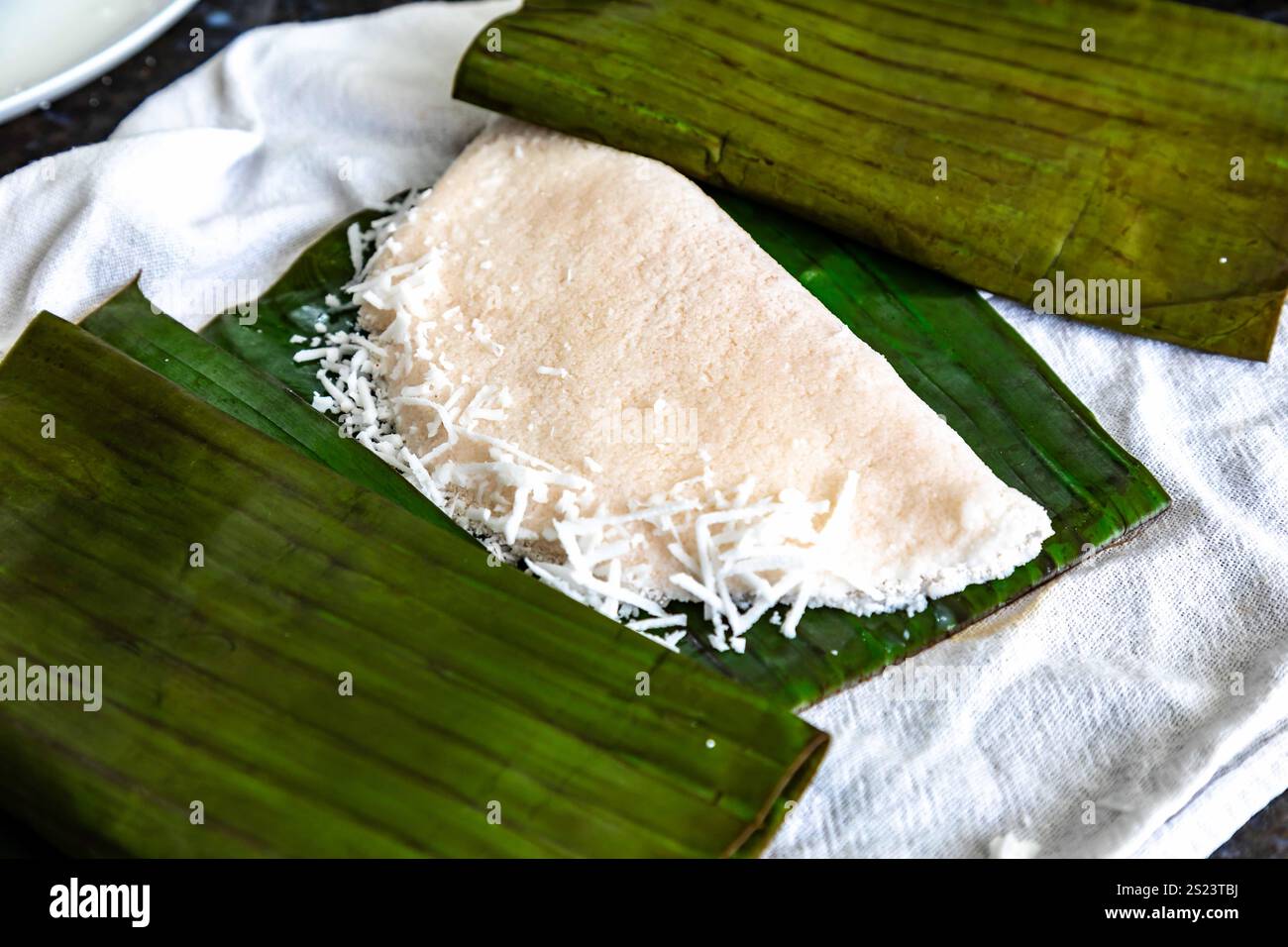 Traditional Brazilian tapioca with coconut served on a banana leaf ...