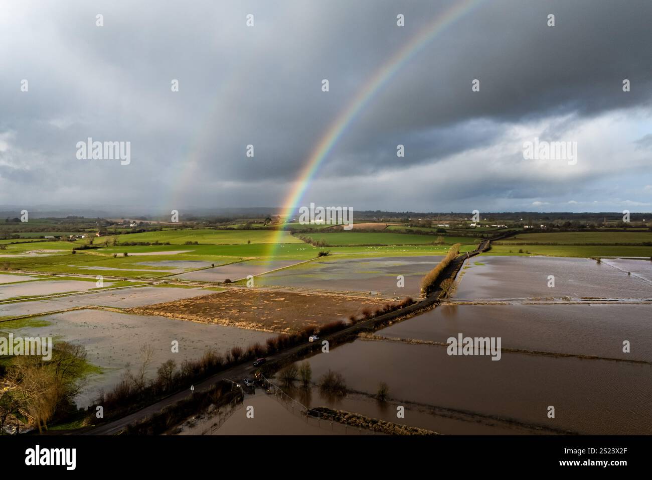 A rainbow is seen over flooded fields near the River Tone in Somerset ...
