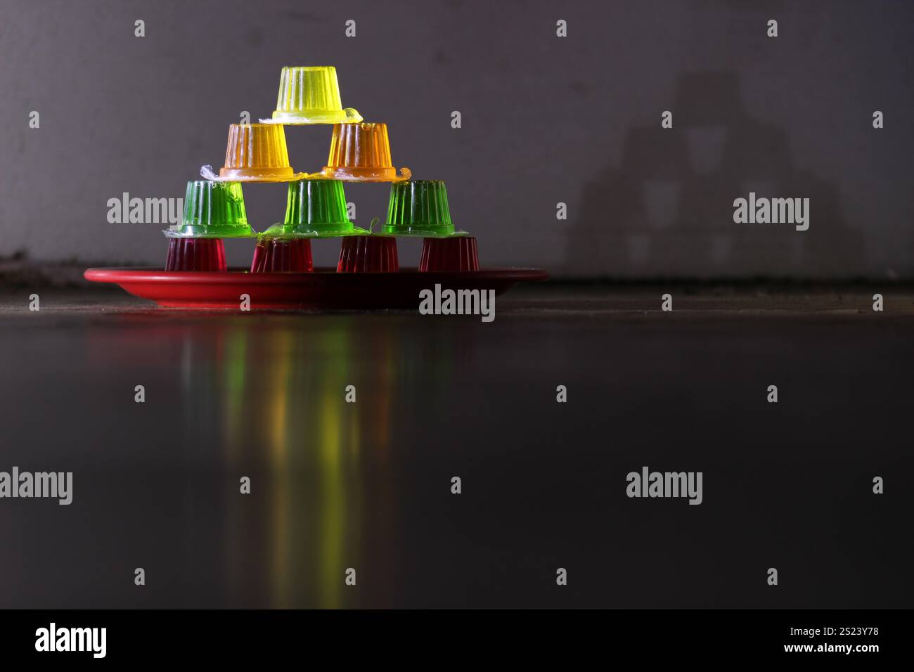 Red surface with pyramid structure as background with light shadow hi ...