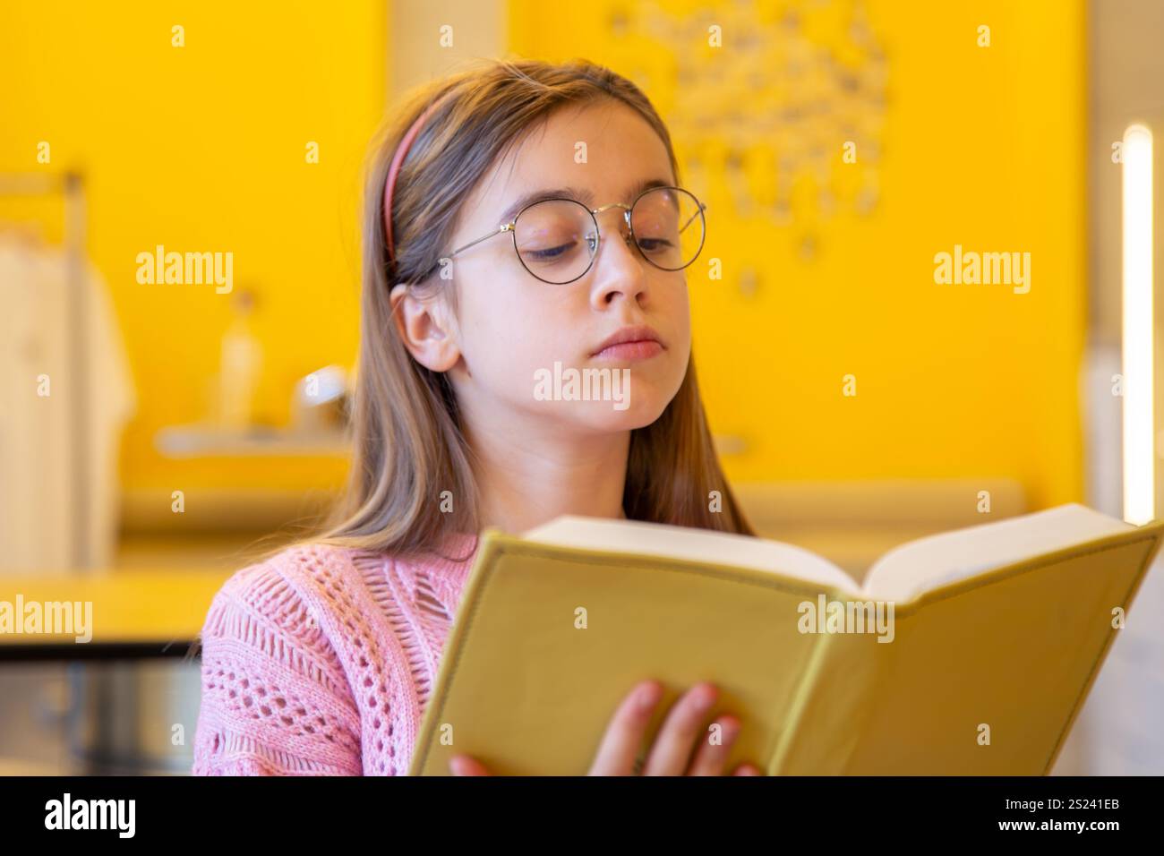 Serious teenage girl reading a book. Emotion concept Stock Photo - Alamy