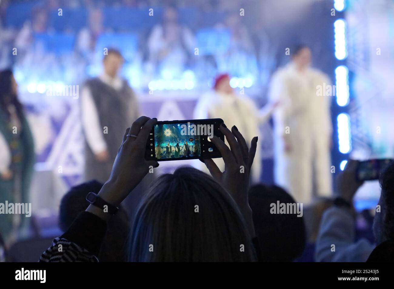 KYIV, UKRAINE - JANUARY 5, 2025 - A woman captures the Traditions of ...