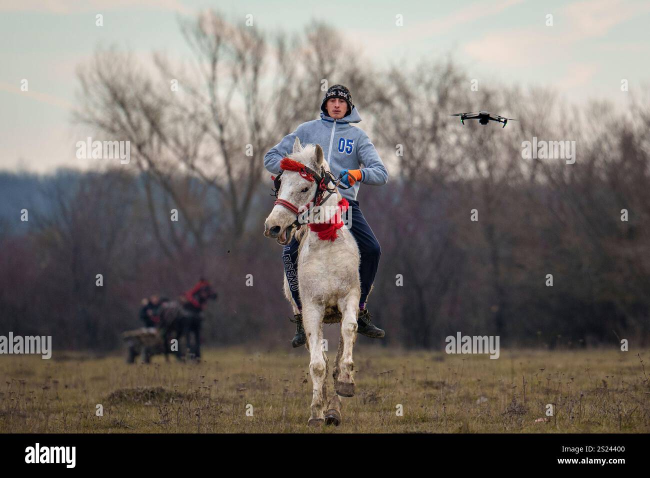 A drone follows a villager warming up his horse before competing in a ...